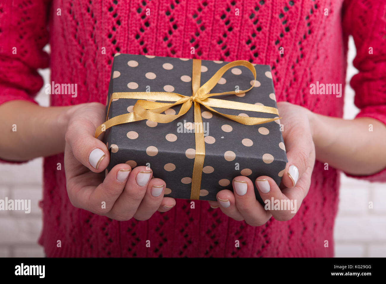 Gift box with ribbon in women's hands Stock Photo - Alamy