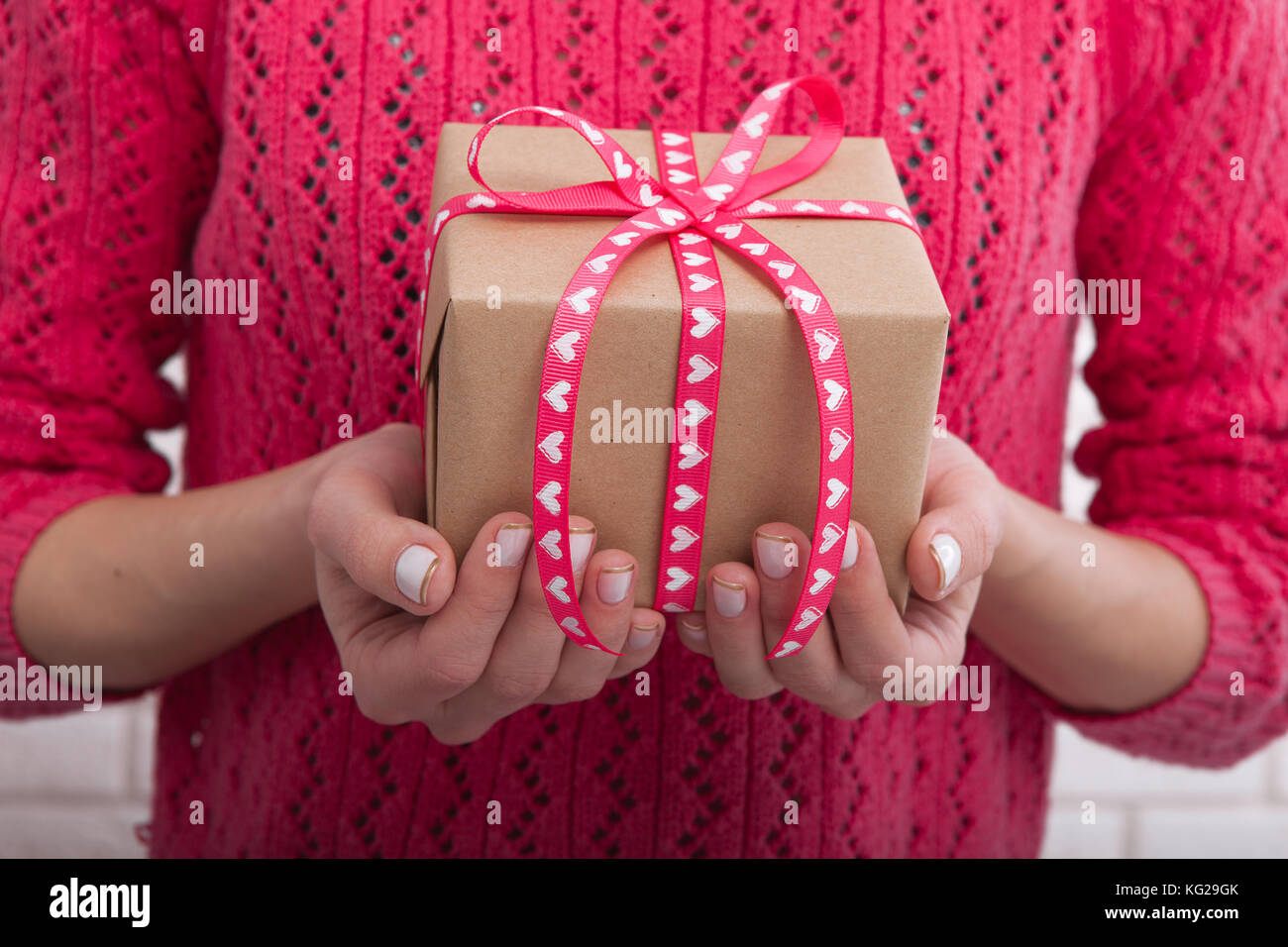 Gift box with ribbon in women's hands Stock Photo - Alamy
