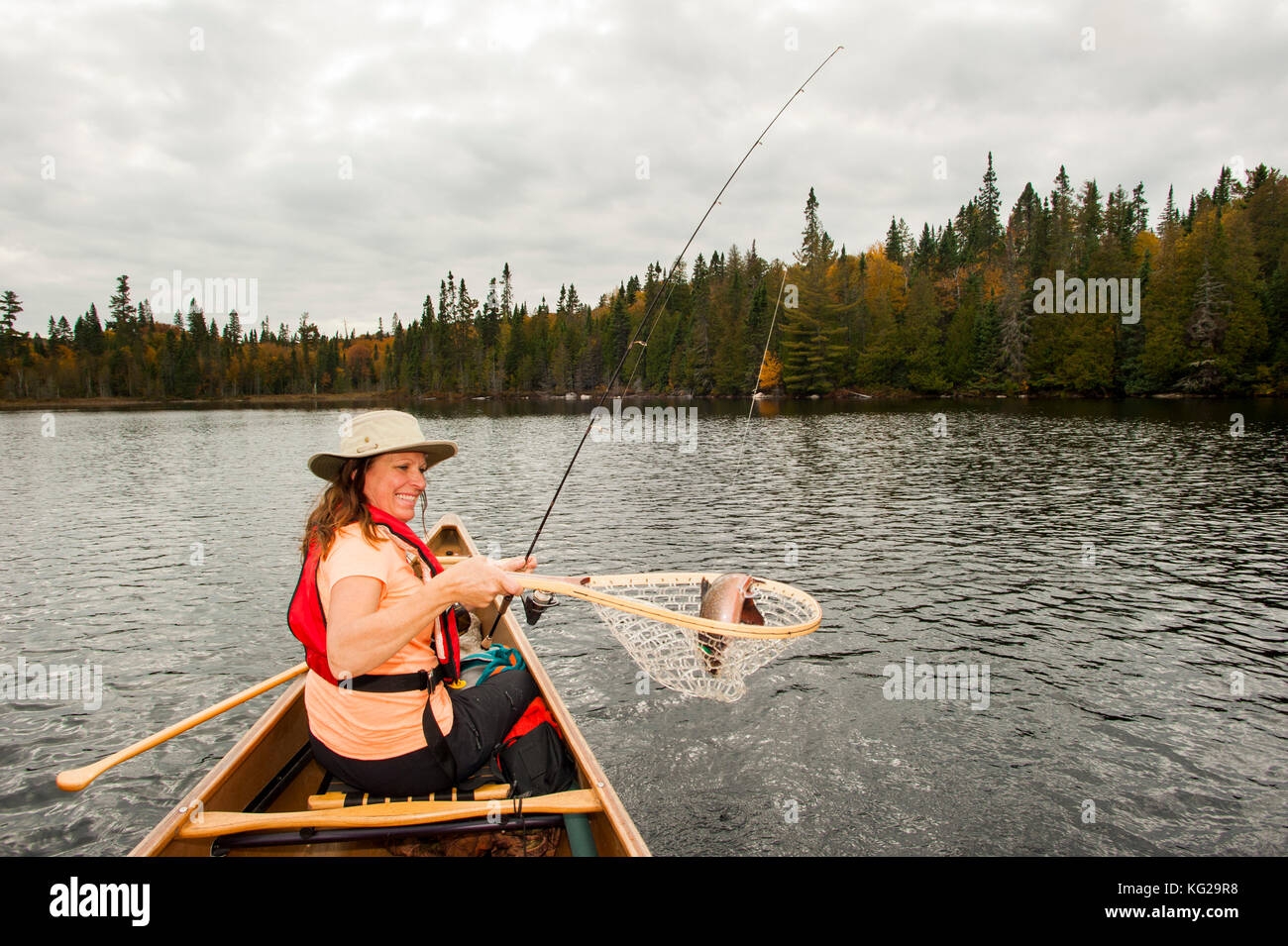 Smiling woman with beautiful brook trout Stock Photo - Alamy