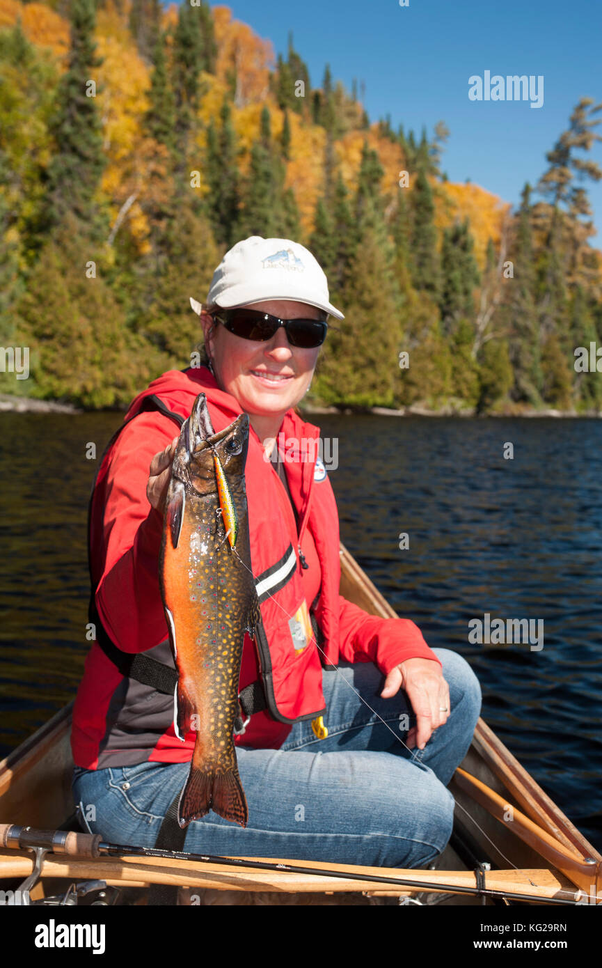 Smiling woman with beautiful brook trout Stock Photo - Alamy