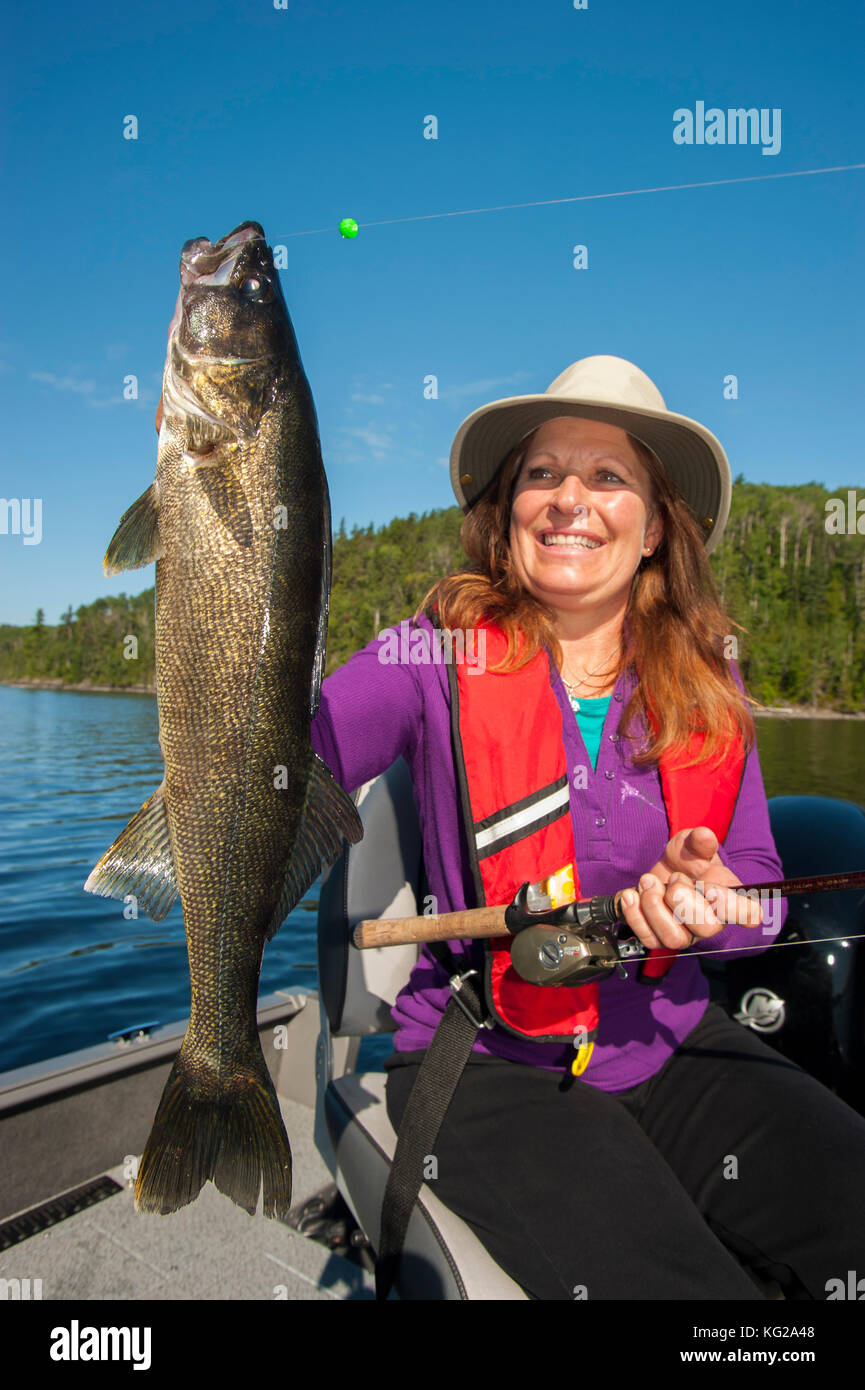 Woman hoisting trophy walleye Stock Photo - Alamy