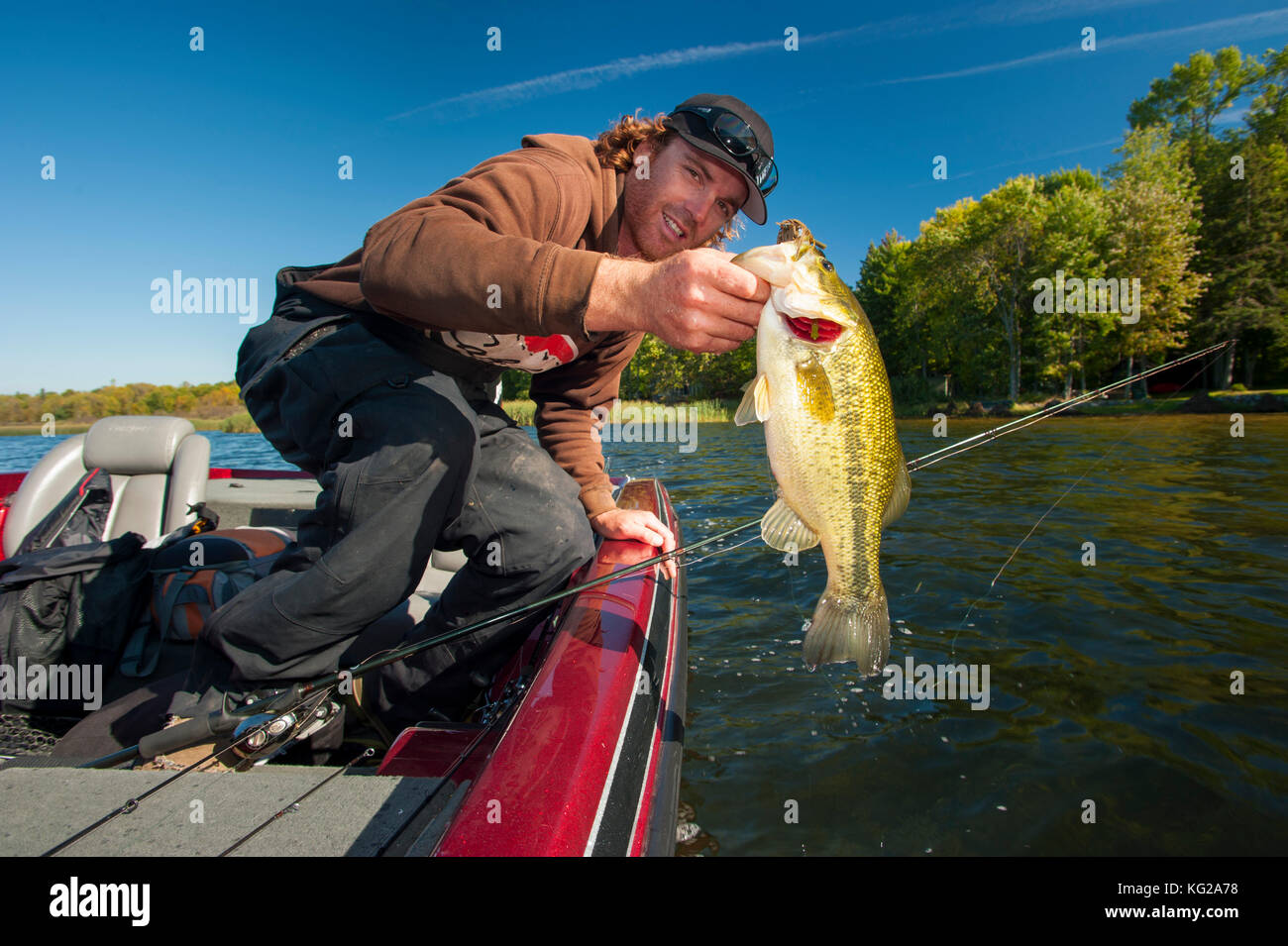 Smiling man gripping smallmouth bass Stock Photo - Alamy