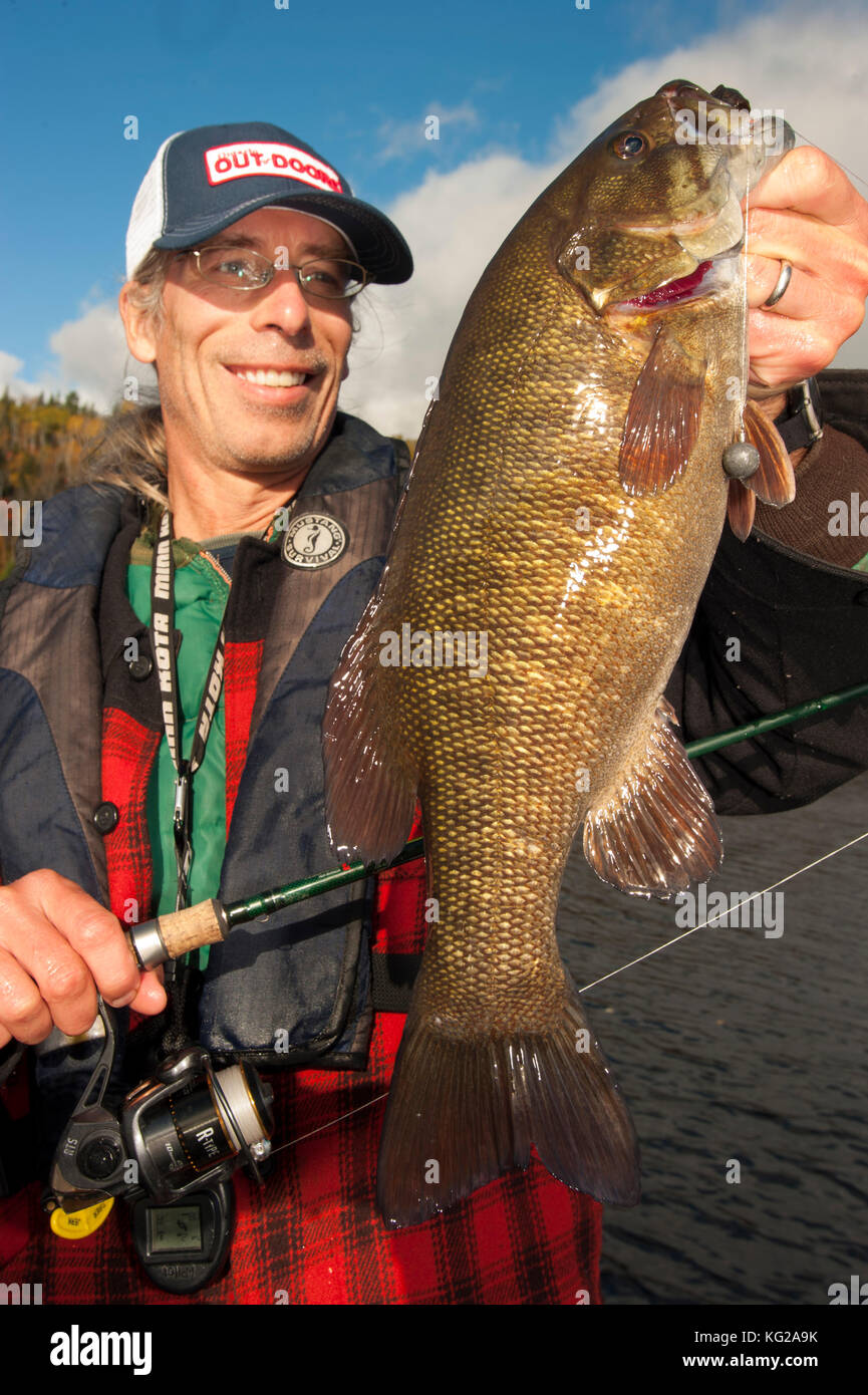 Angler with smallmouth bass Stock Photo - Alamy