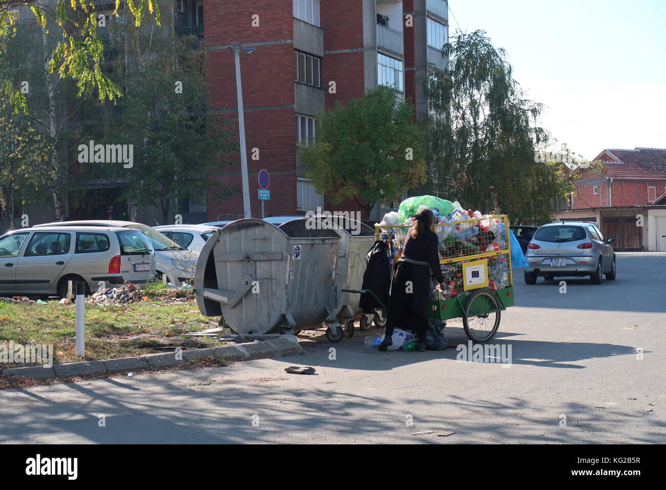 Poor woman collecting plastic bottles for recycling Stock Photo - Alamy
