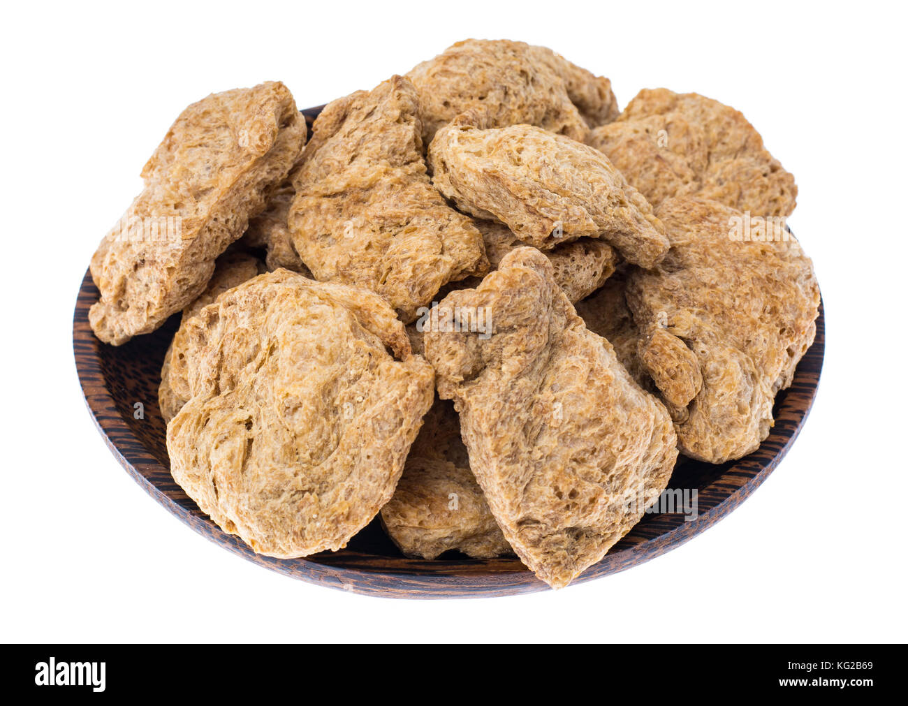 Dry soy slices of meat in wooden plate on white background. Studio ...