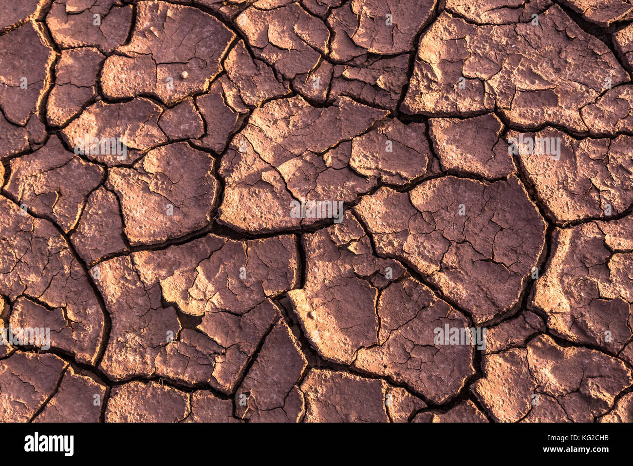 Earth dried and broken in strong sun Stock Photo - Alamy