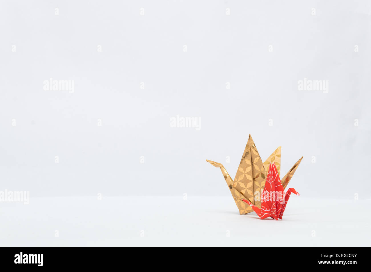 Two origami cranes and a white background Stock Photo - Alamy