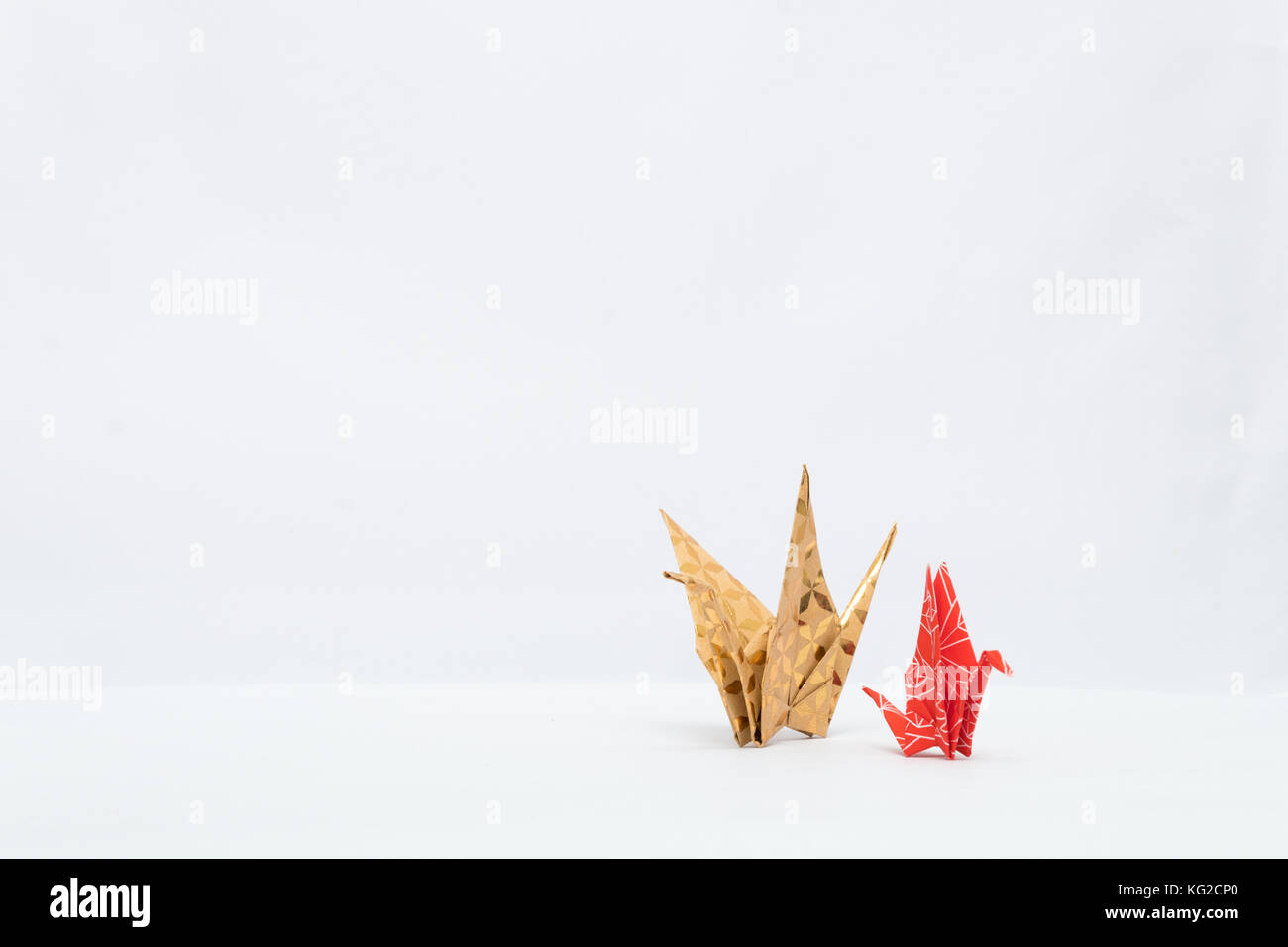 Two origami cranes and a white background Stock Photo - Alamy