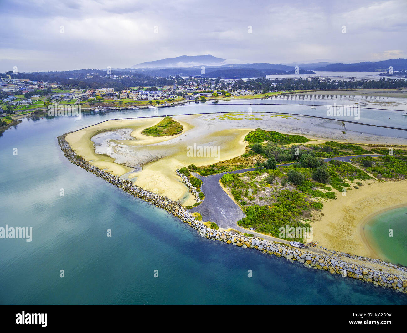 Aerial view of Narooma inlet - residential buildings, shallow water ...