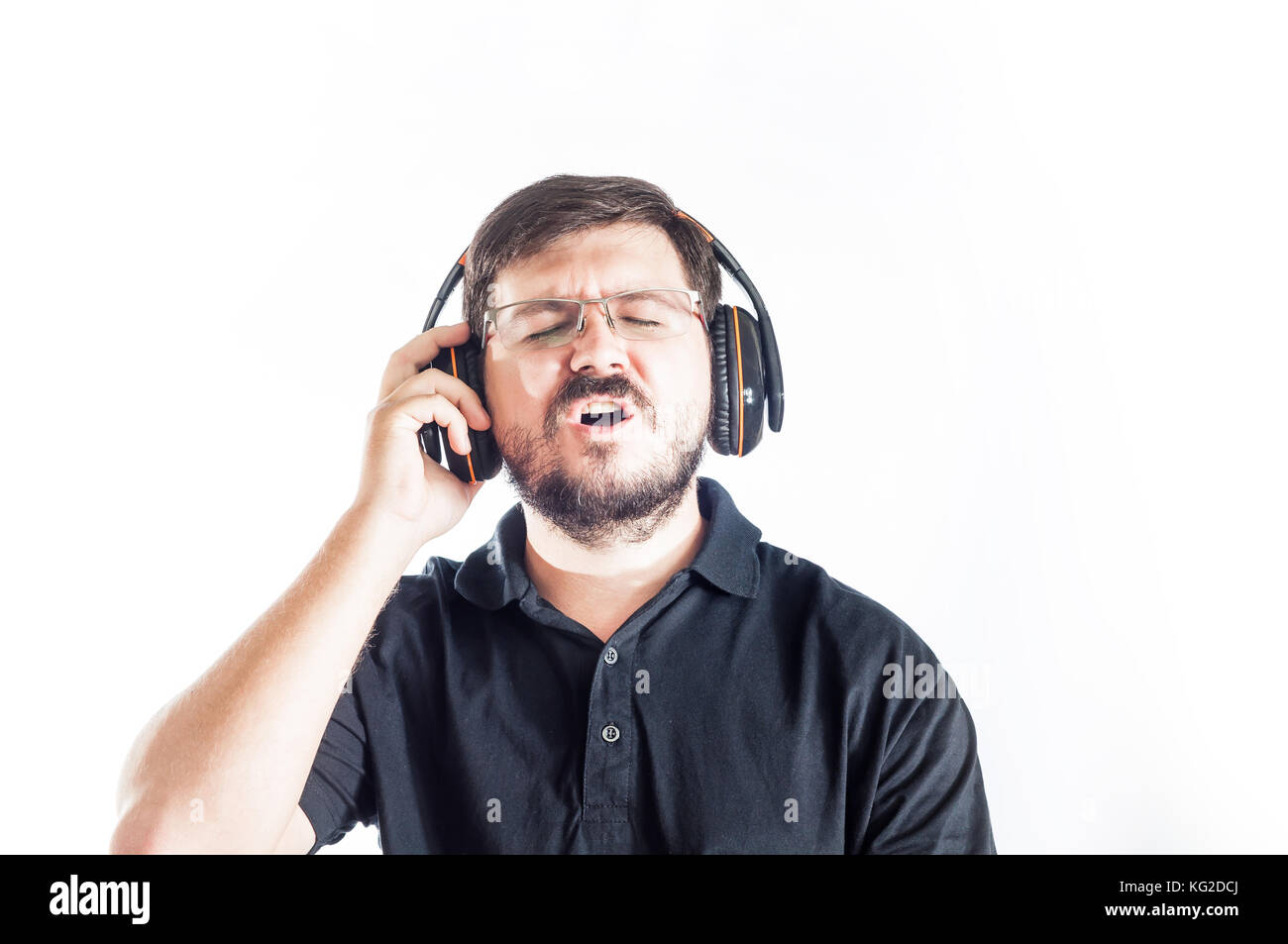 Caucasian man listen music from headphones and singing song on white ...