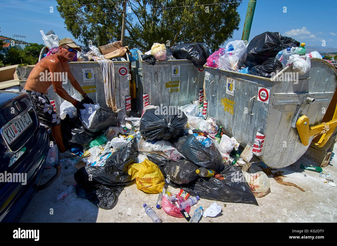 Man searching through garbage Stock Photo - Alamy
