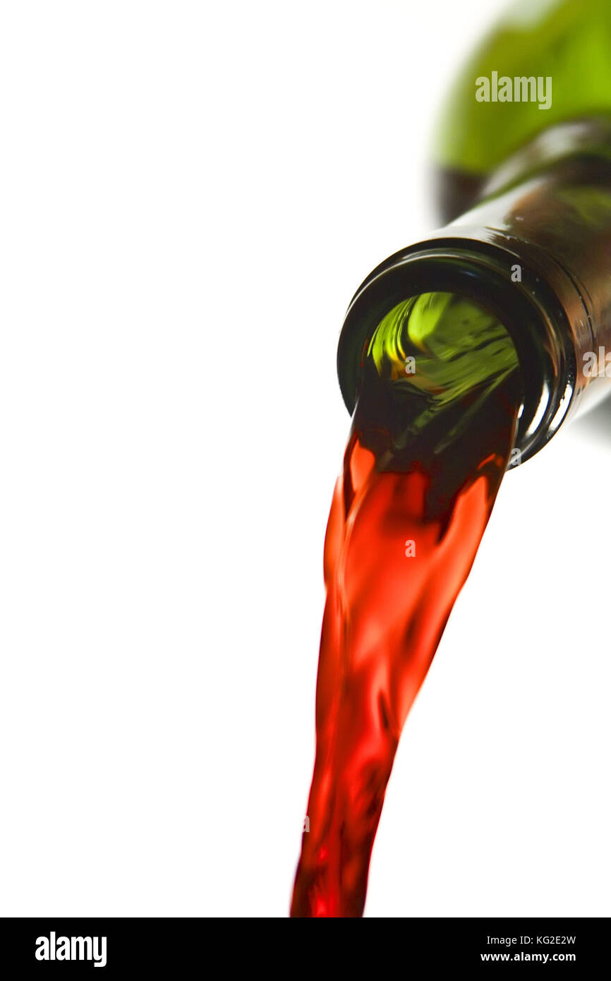 Red wine being poured out on white background Stock Photo - Alamy
