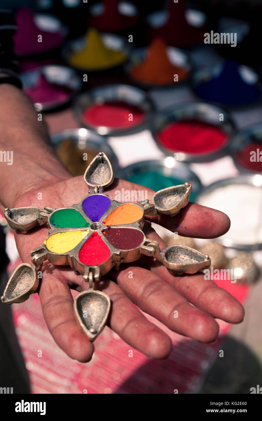Hand offers colorful India ink in star-shaped holder Stock Photo - Alamy