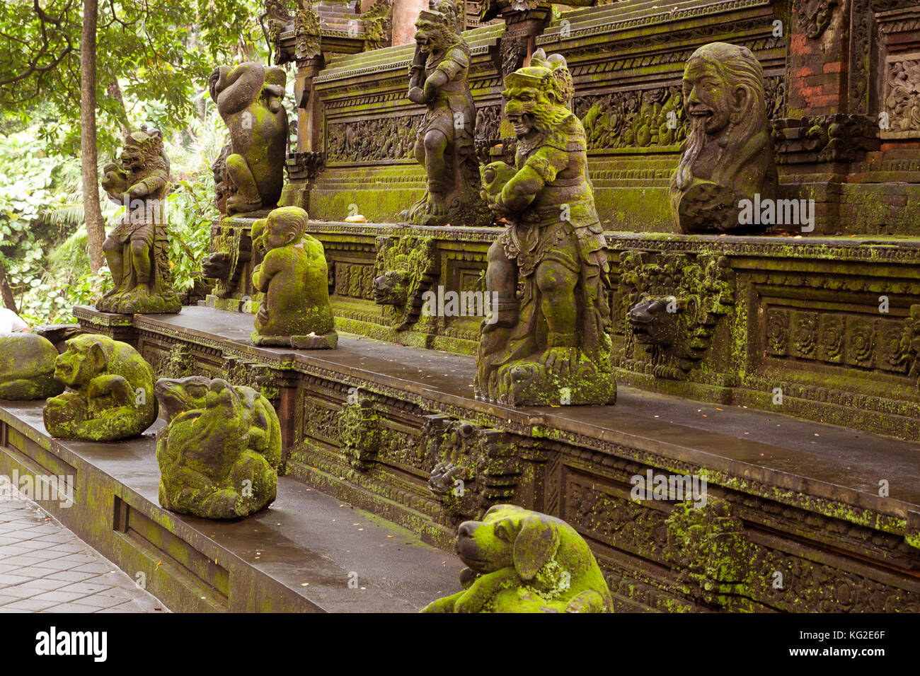 Statues covered in green moss on Monkey Forest Ubud, Bali Stock Photo ...