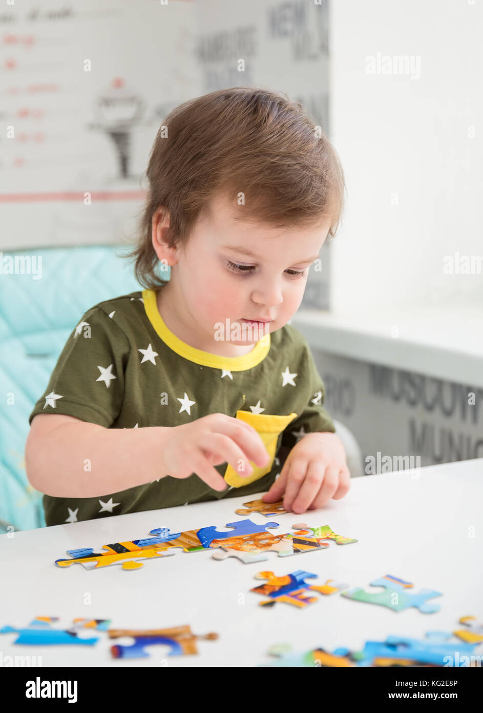Little boy or toddler playing with a puzzle, child development concept ...