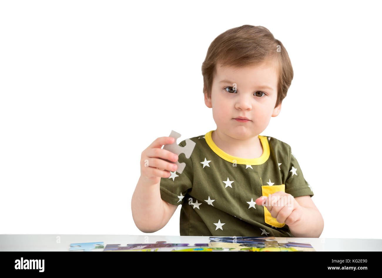 Cute baby boy or toddler playing with a puzzle, look at the camera. On ...