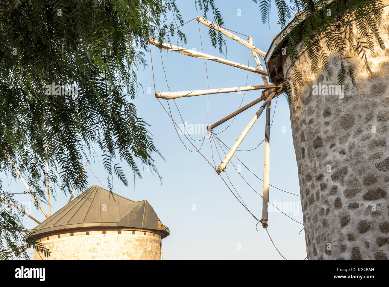 Close detailed view of ancient stone windmill on clean blue sky ...