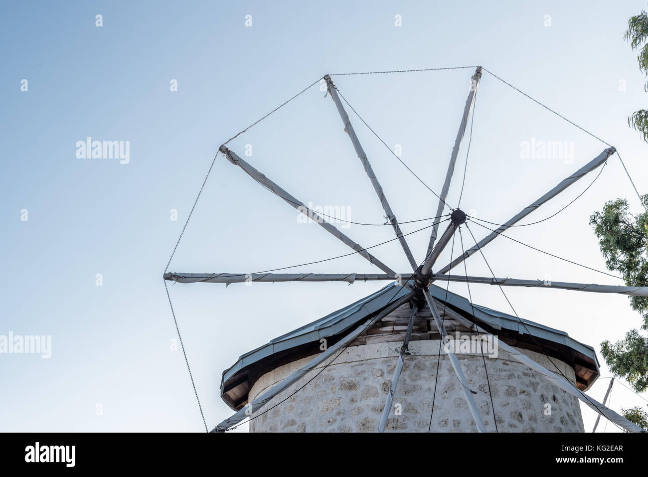 Close detailed view of ancient stone windmill on clean blue sky ...