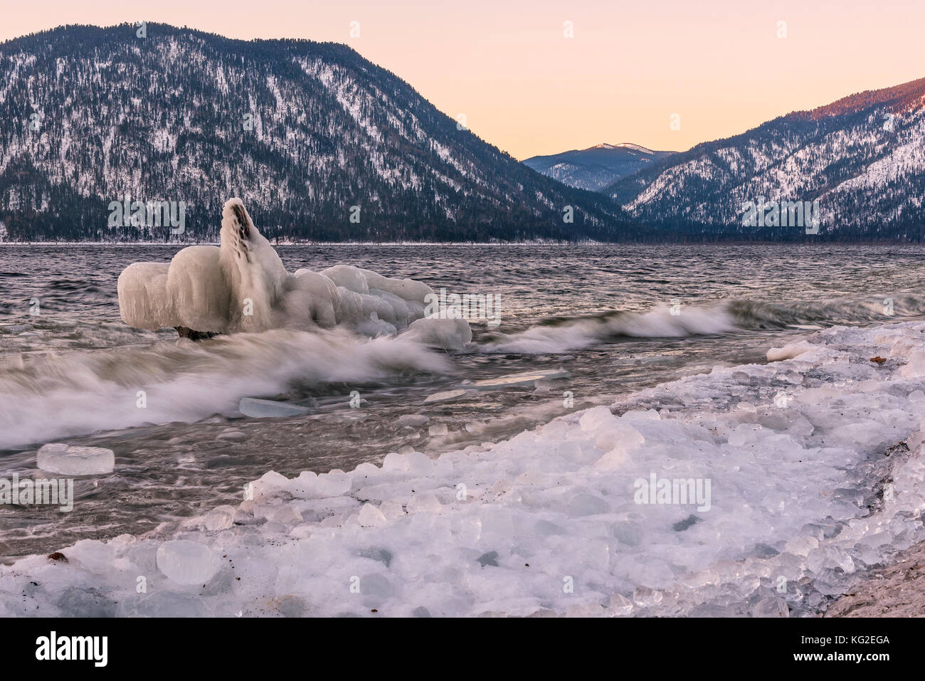 Beautiful winter landscape with a lake, iceberg on the water and ice on ...