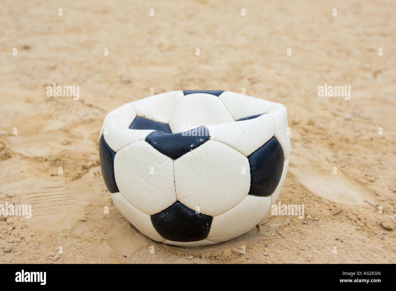 deflated ball forgotten on the football field abandoned Stock Photo - Alamy
