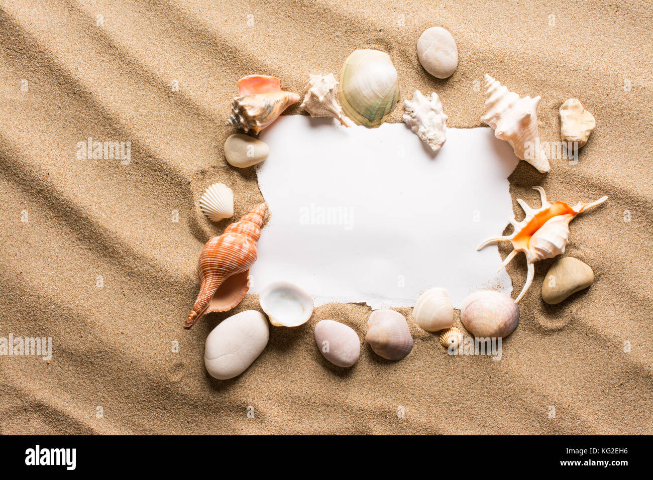 Message in torn paper on the beach. Summer background with hot sand ...
