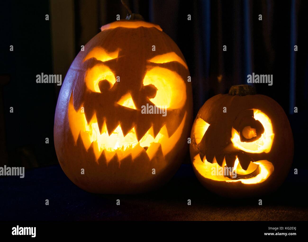 Big and small carved pumpkins with lights inside and spooky faces Stock ...