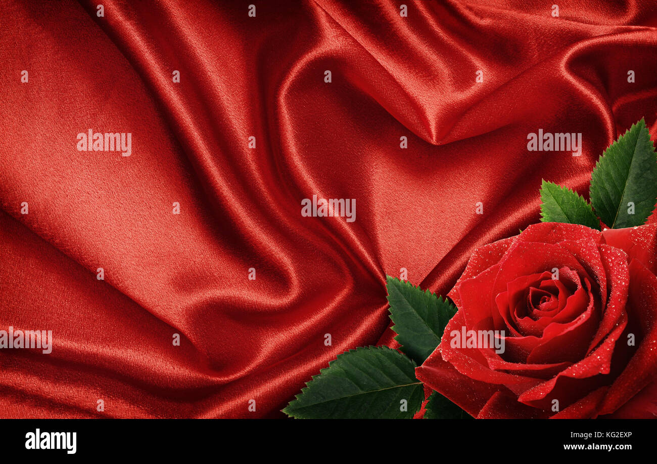 Red satin fabric draped in the form of heart and red rose for Valentine ...