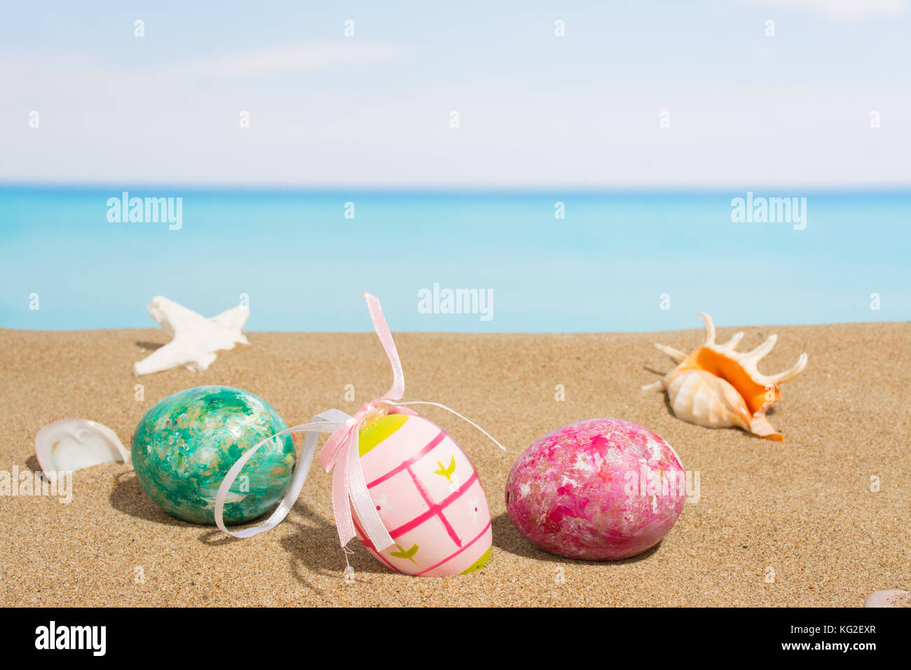 Easter on beach background. Eggs on the sandy by the ocean. Vacation ...