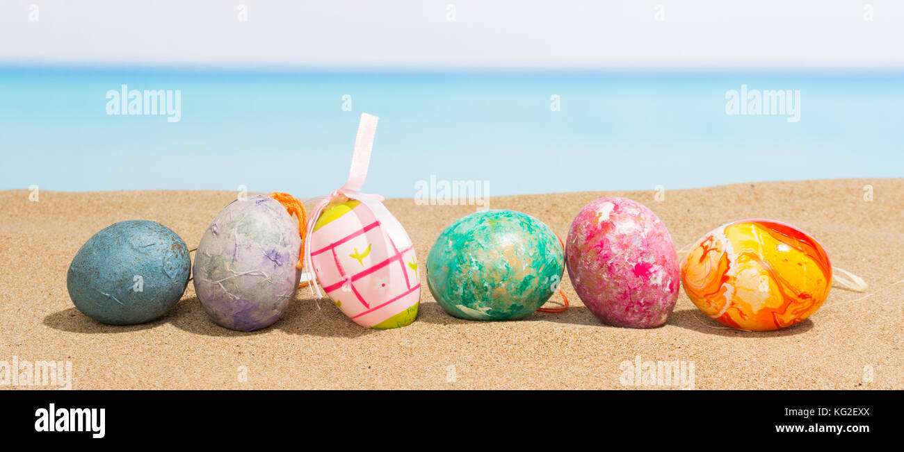 Easter on beach background. Eggs on the sandy by the ocean. Vacation ...