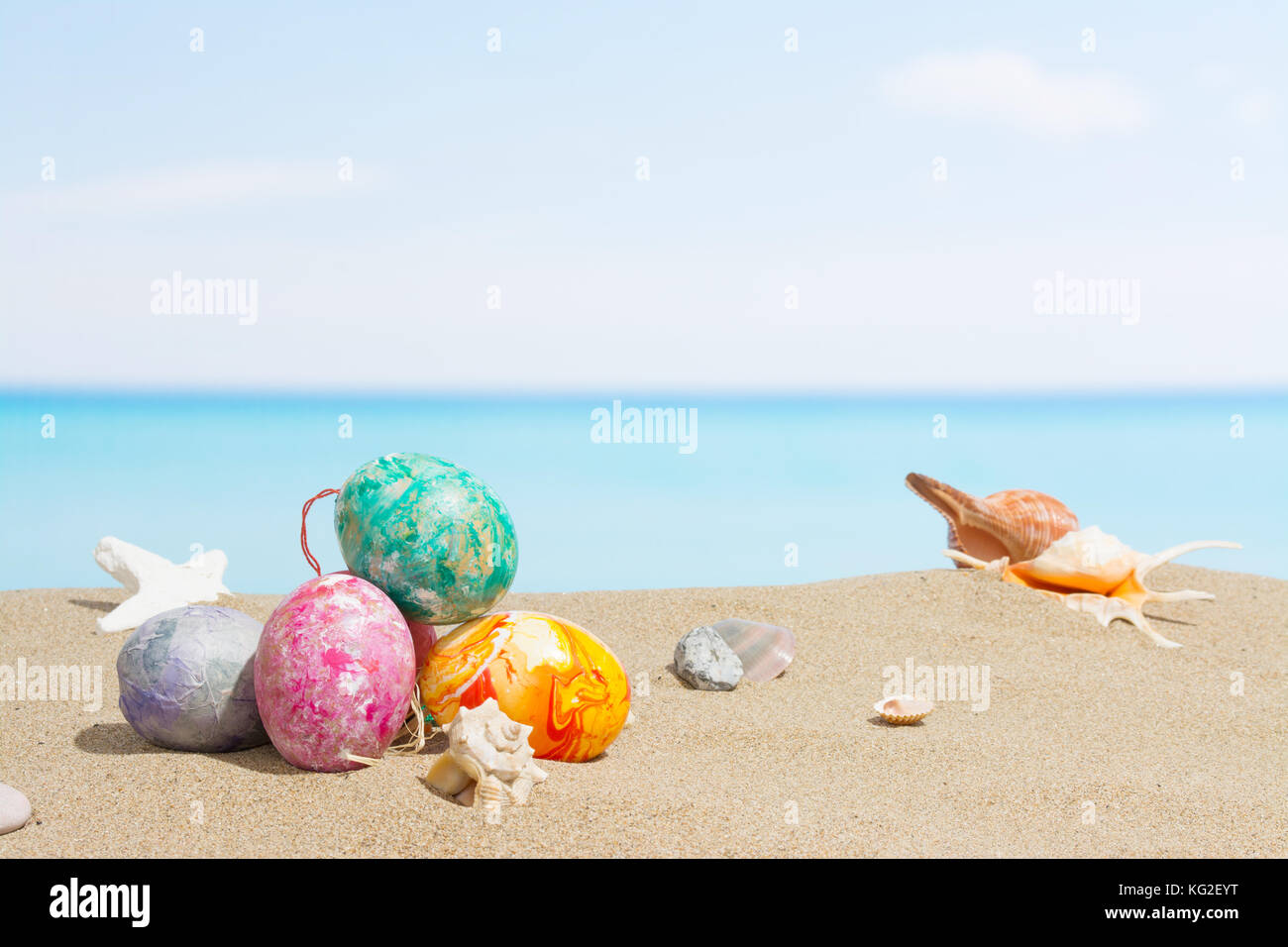 Easter on beach background. Eggs on the sandy by the ocean. Vacation ...