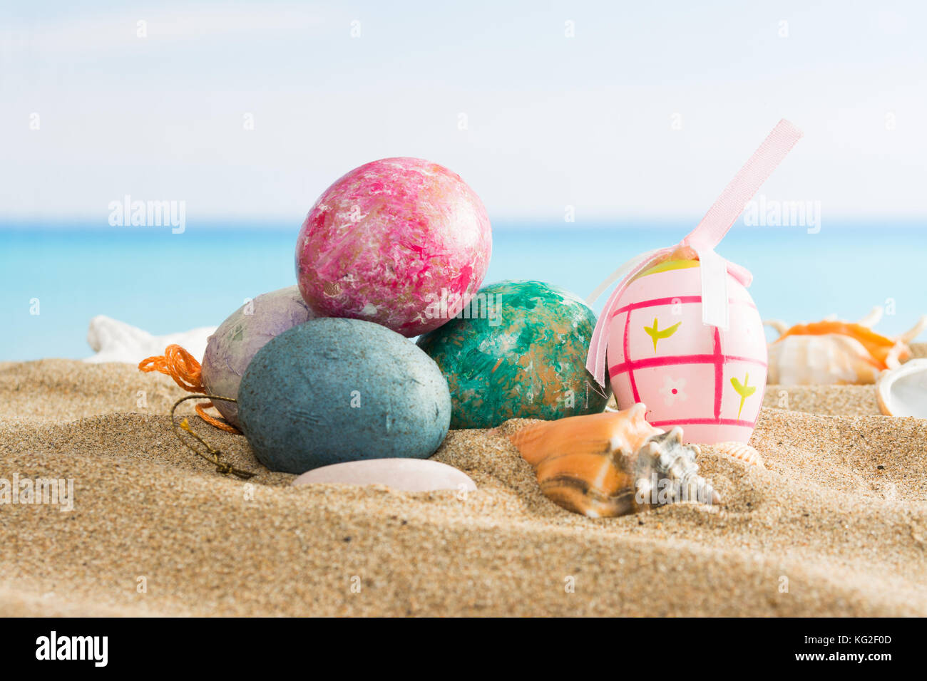 Easter on beach background. Eggs on the sandy by the ocean. Vacation ...