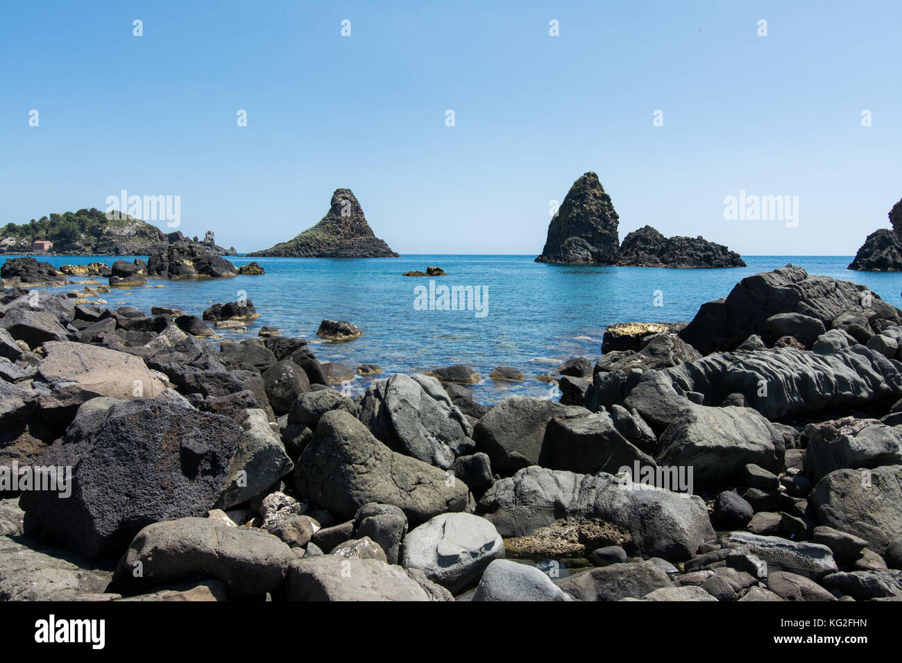 Cyclops islands, Acitrezza, Sicily. Basalt rocks on the sea Stock Photo ...