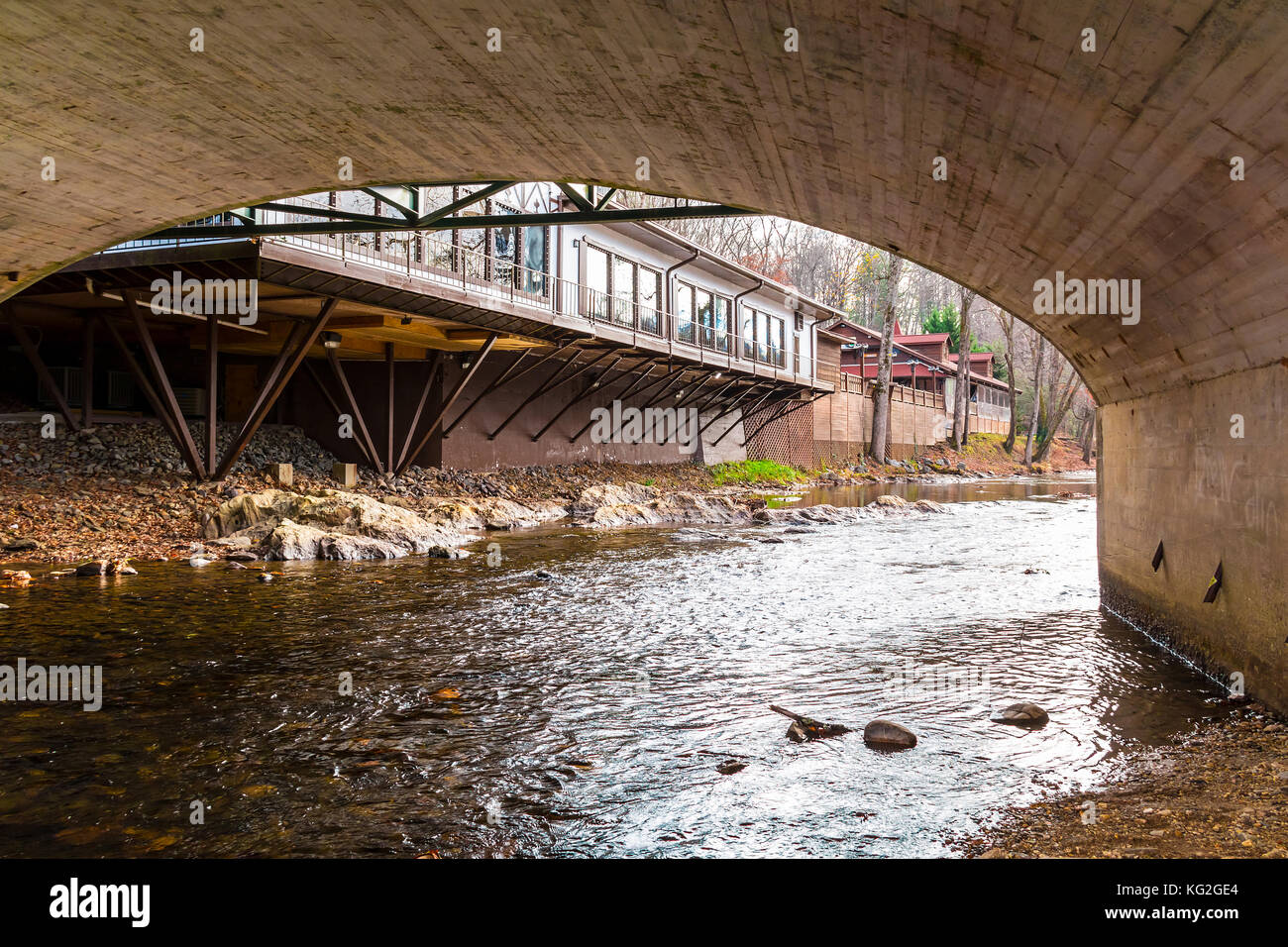 Chattahoochee river, arch of bridge over it and buildings on its shore ...