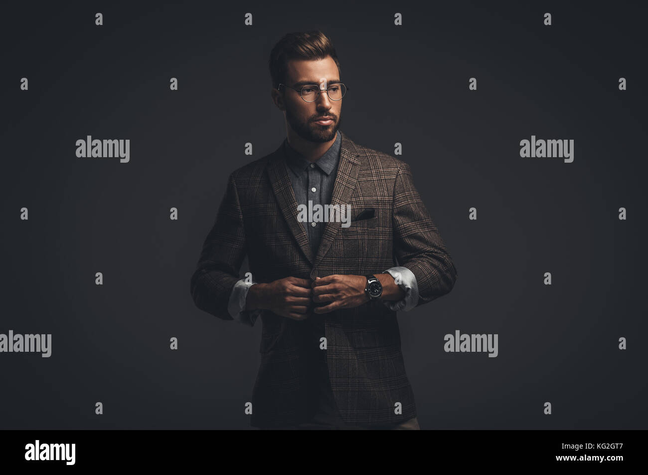 Sophisticated man adjusting jacket Stock Photo - Alamy