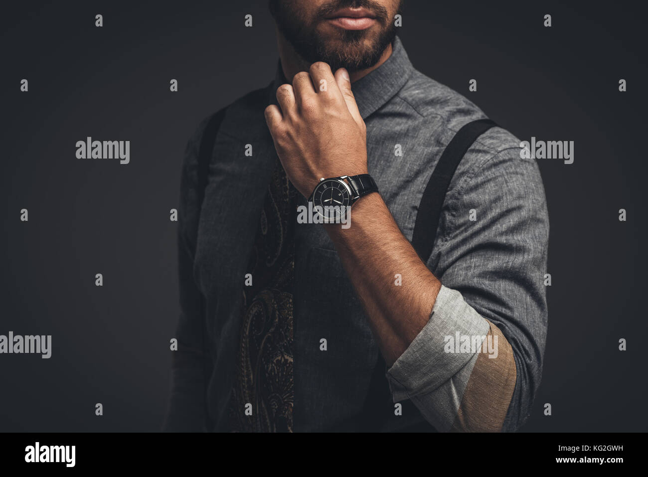 Young man scratching beard Stock Photo - Alamy