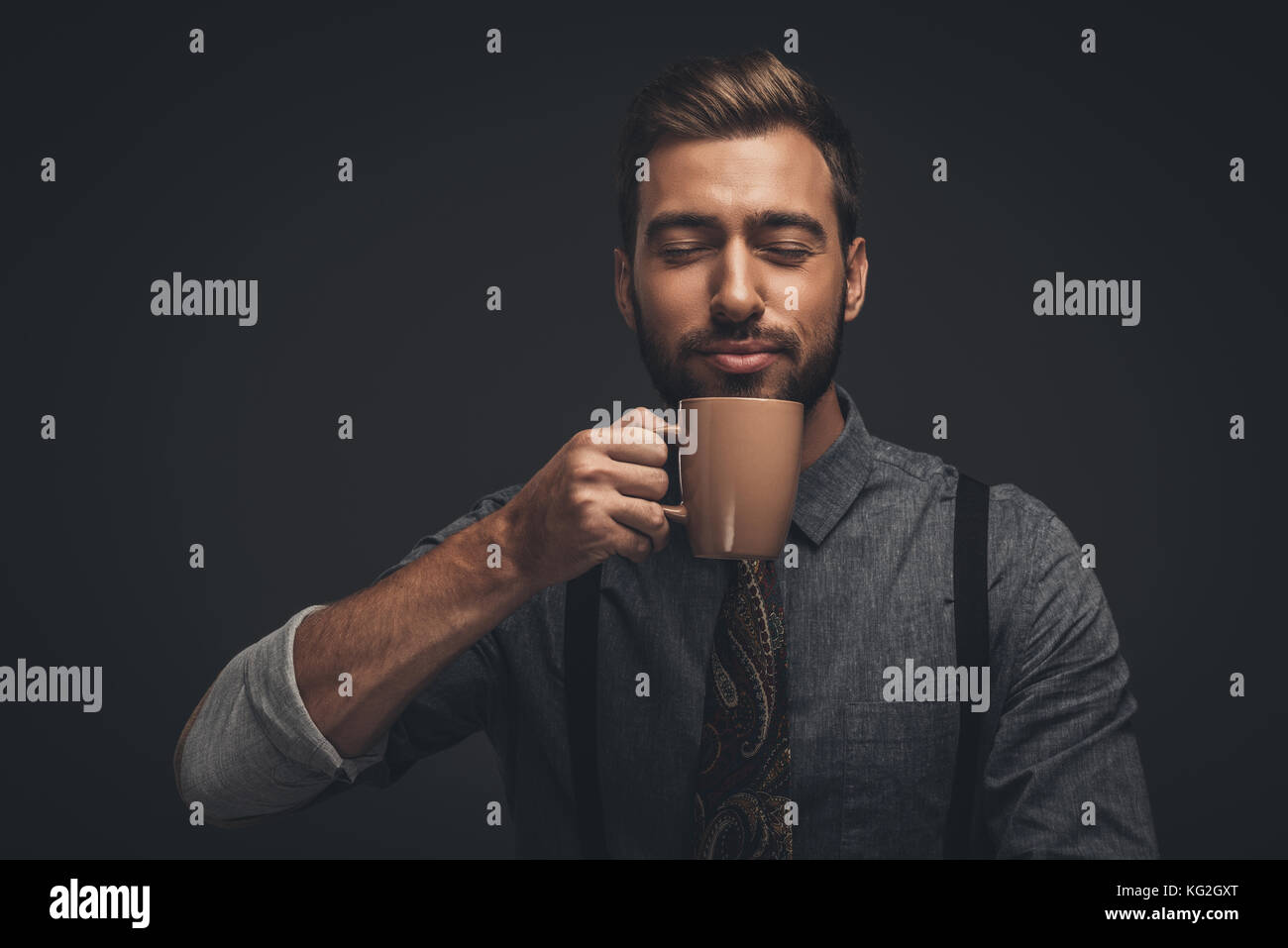 Handsome man smelling coffee Stock Photo - Alamy