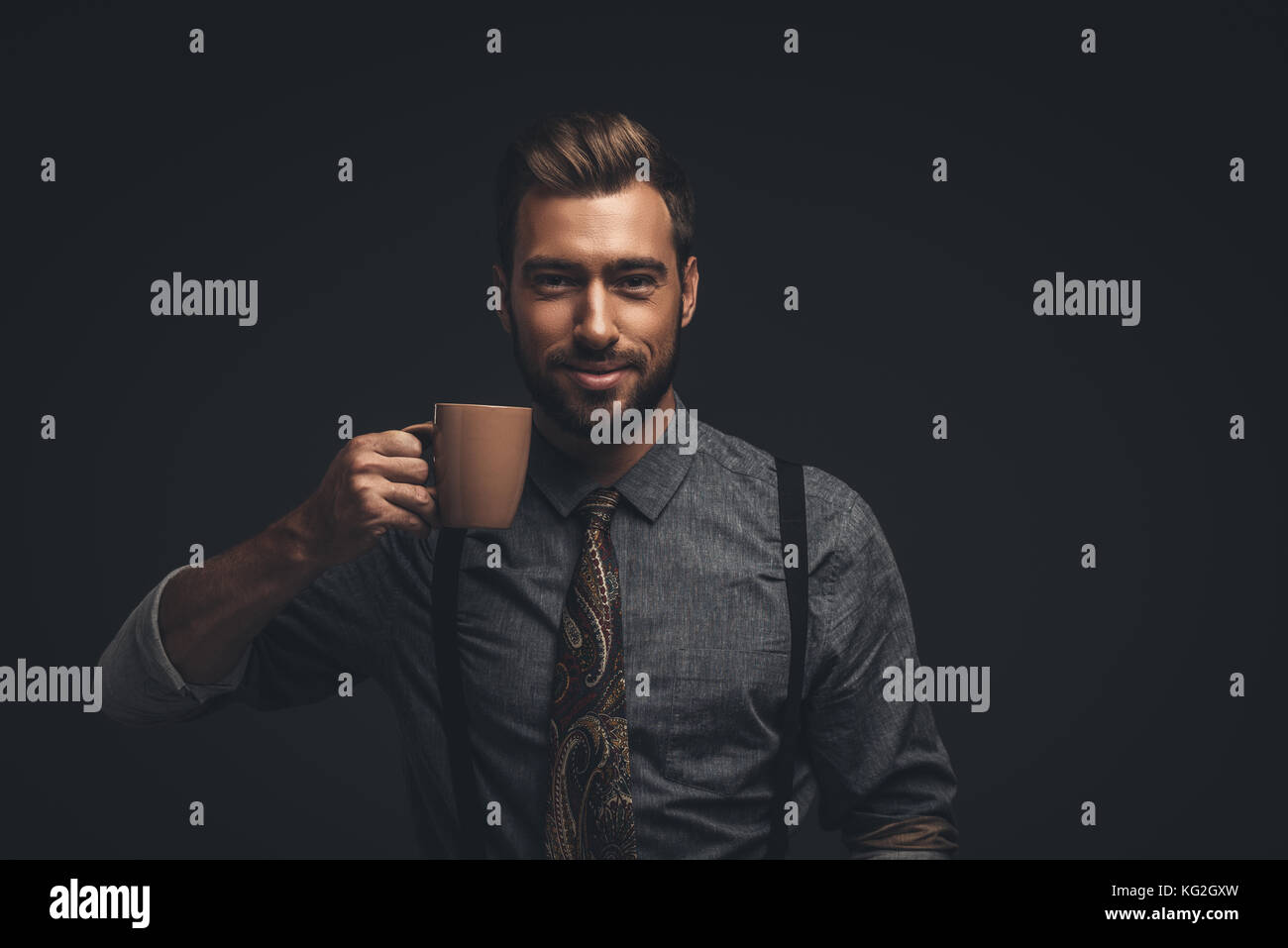 Smiling man holding cup of coffee Stock Photo - Alamy