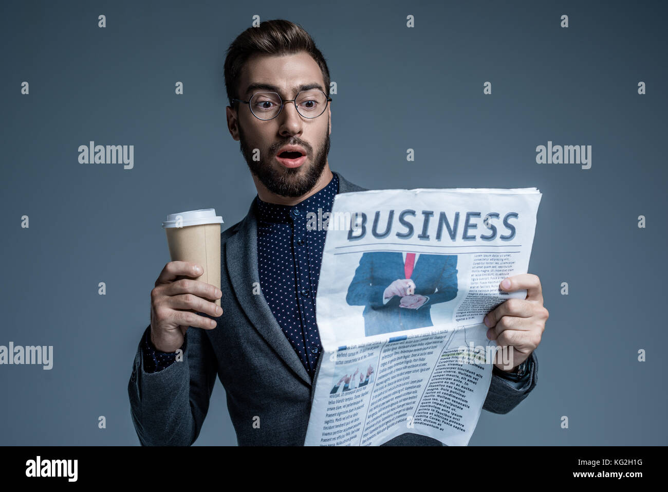 Surprised businessman reading newspaper Stock Photo - Alamy
