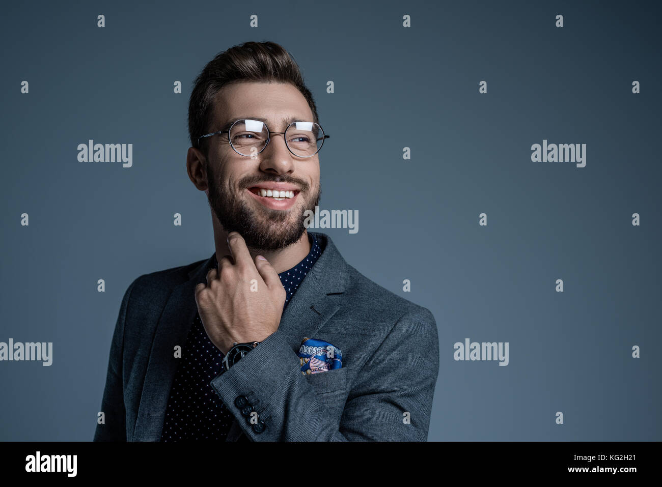 man in suit scratching beard Stock Photo - Alamy