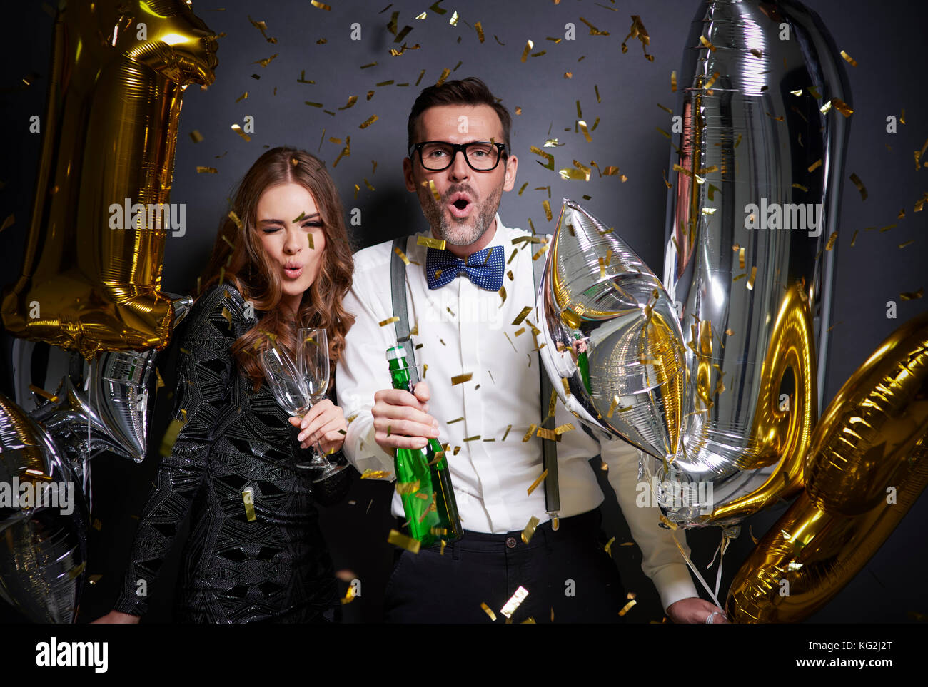 Friends dancing and drinking alcohol at new year celebration Stock ...