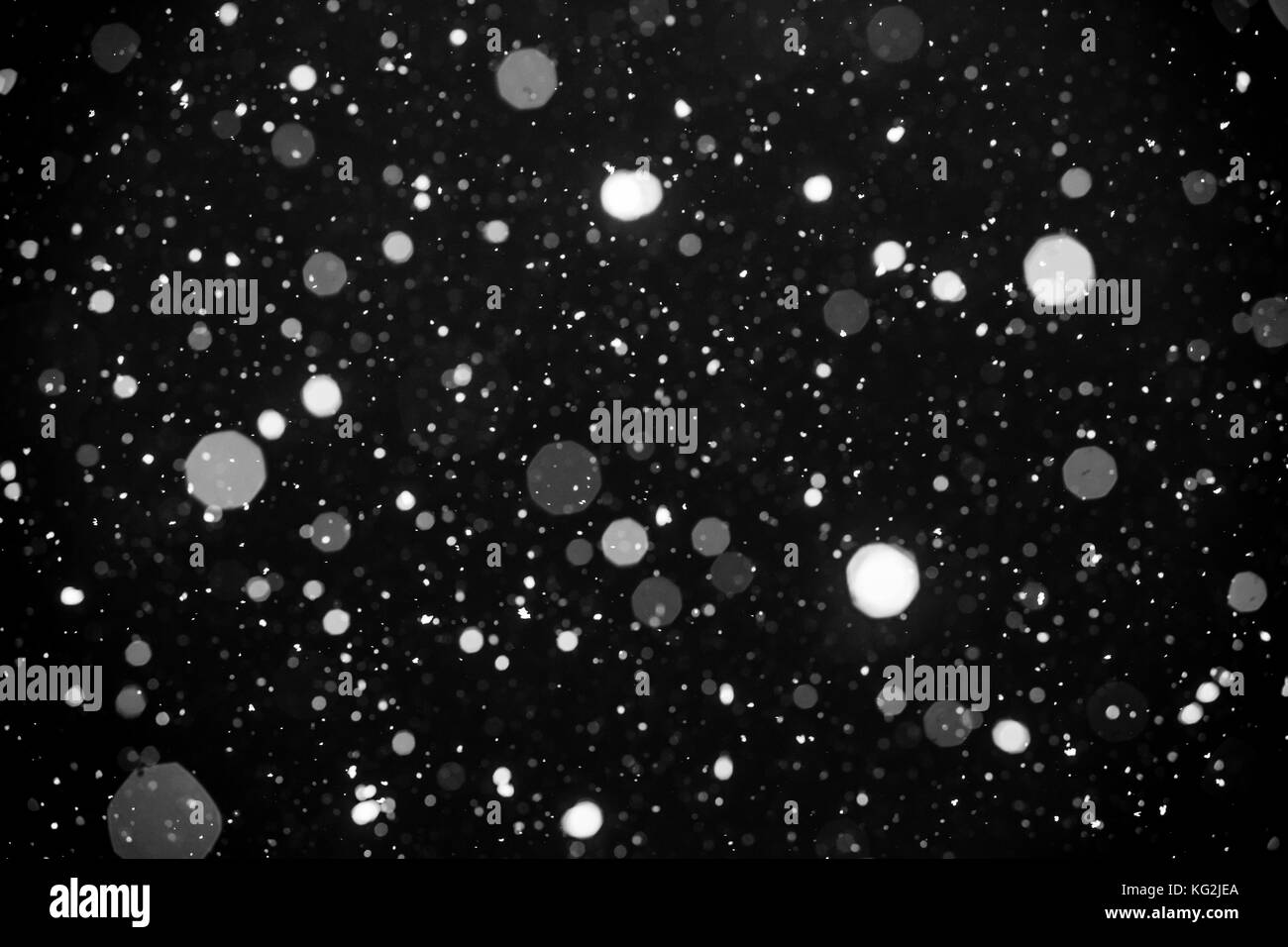 Falling snow on black background Stock Photo - Alamy