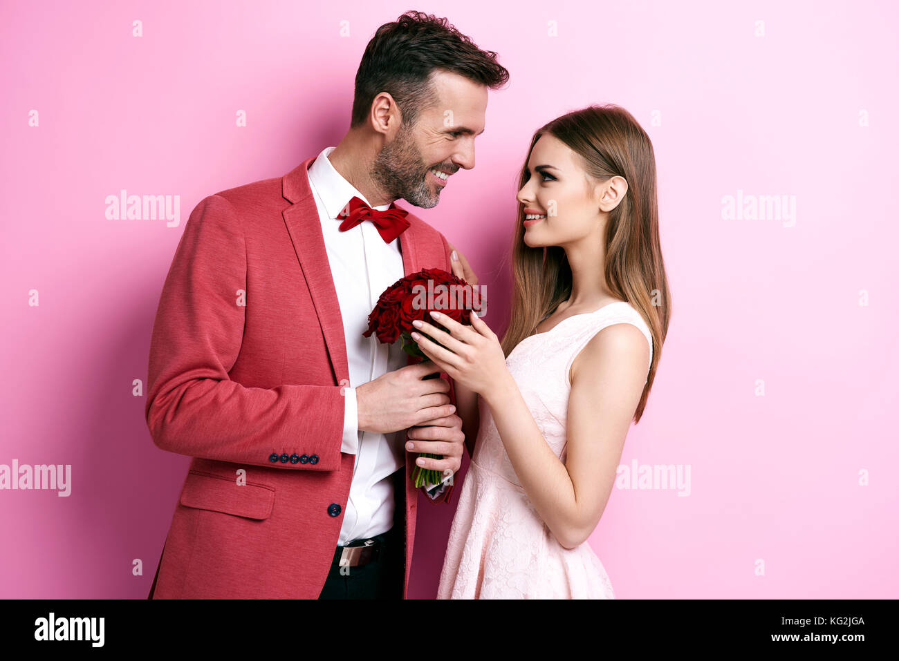 Enamored man with bunch of rose flirting Stock Photo - Alamy