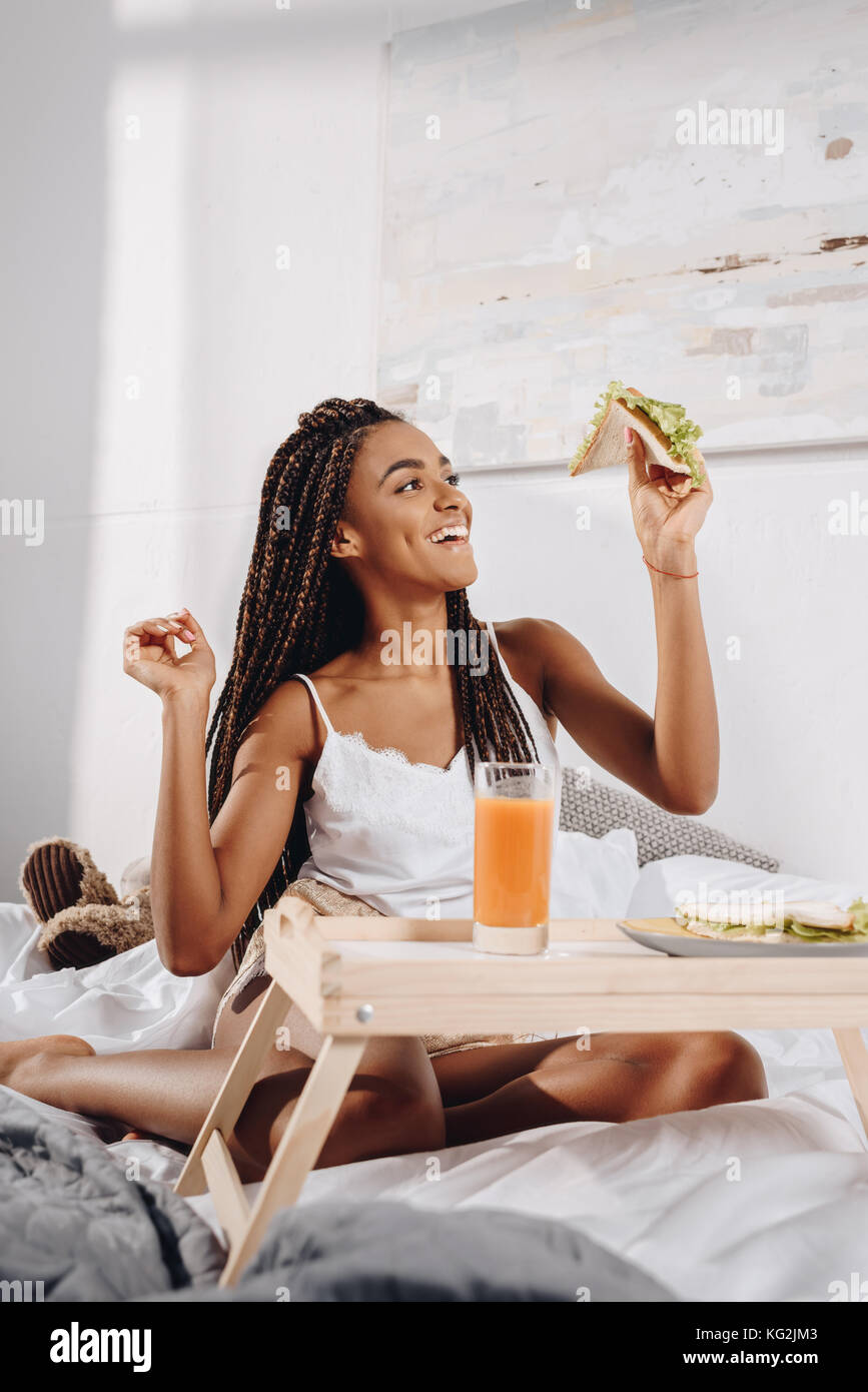 woman eating breakfast in bed Stock Photo - Alamy