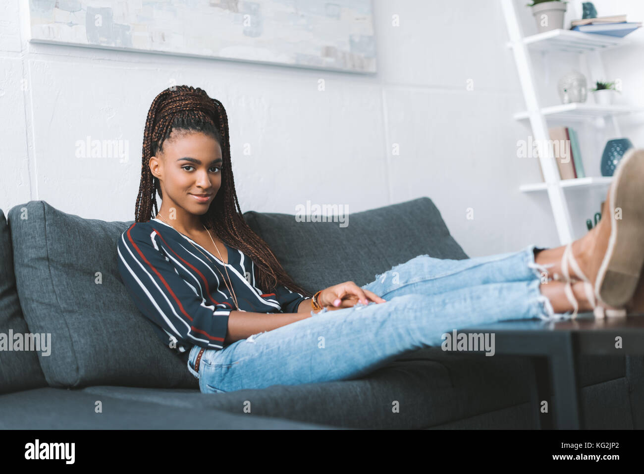Afro american woman relaxing on couch hi-res stock photography and ...