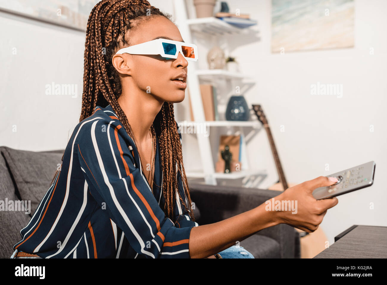 woman watching tv in 3d goggles Stock Photo - Alamy