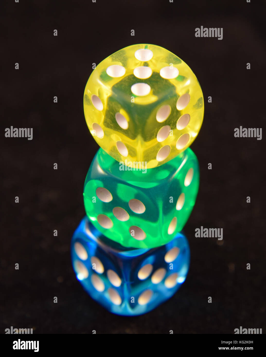 A collection of three colourful plastic dice Stock Photo - Alamy