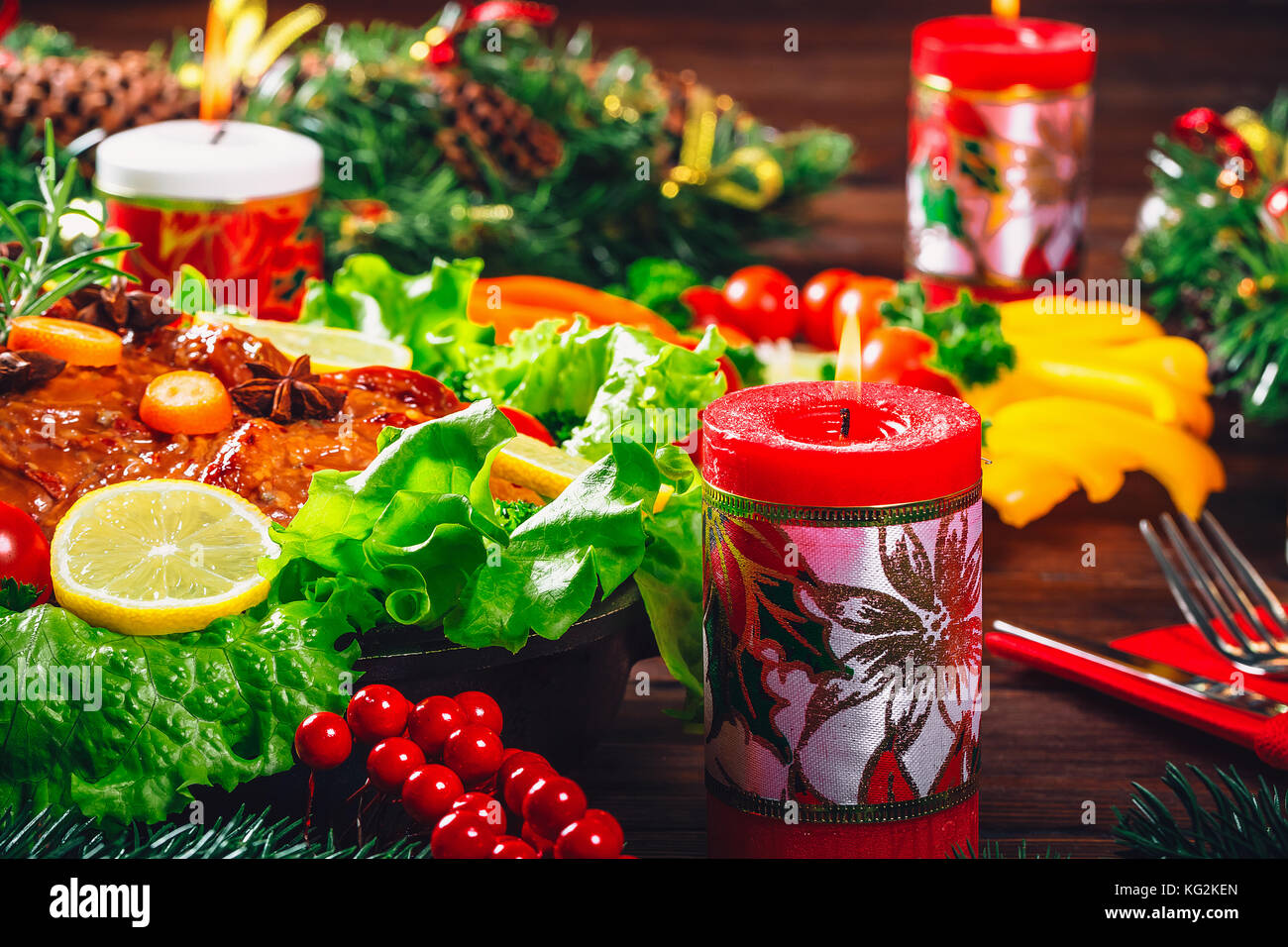 Christmas table dinner time with roasted meats, candles and New Year ...