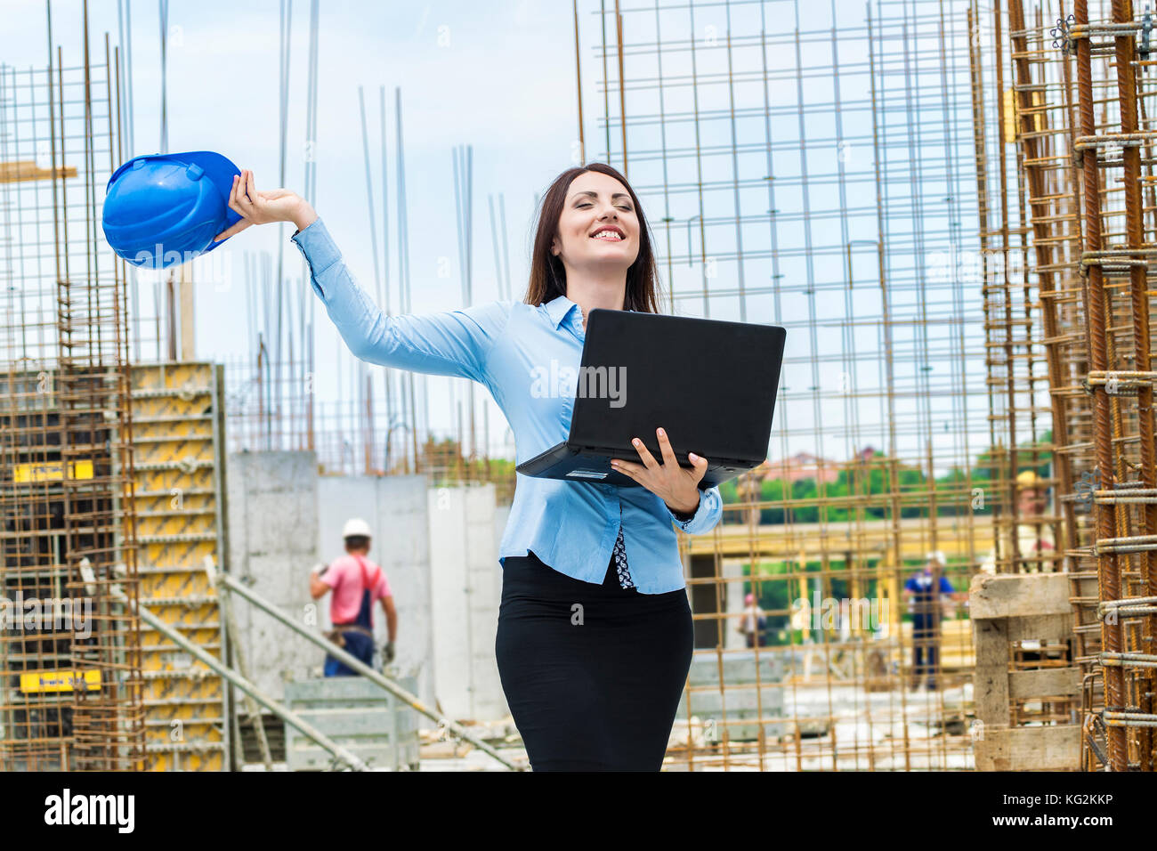 Beautiful woman engineer at construction site ,holding laptop and ...