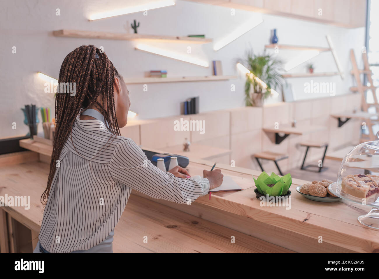 barista writing in notebook Stock Photo - Alamy