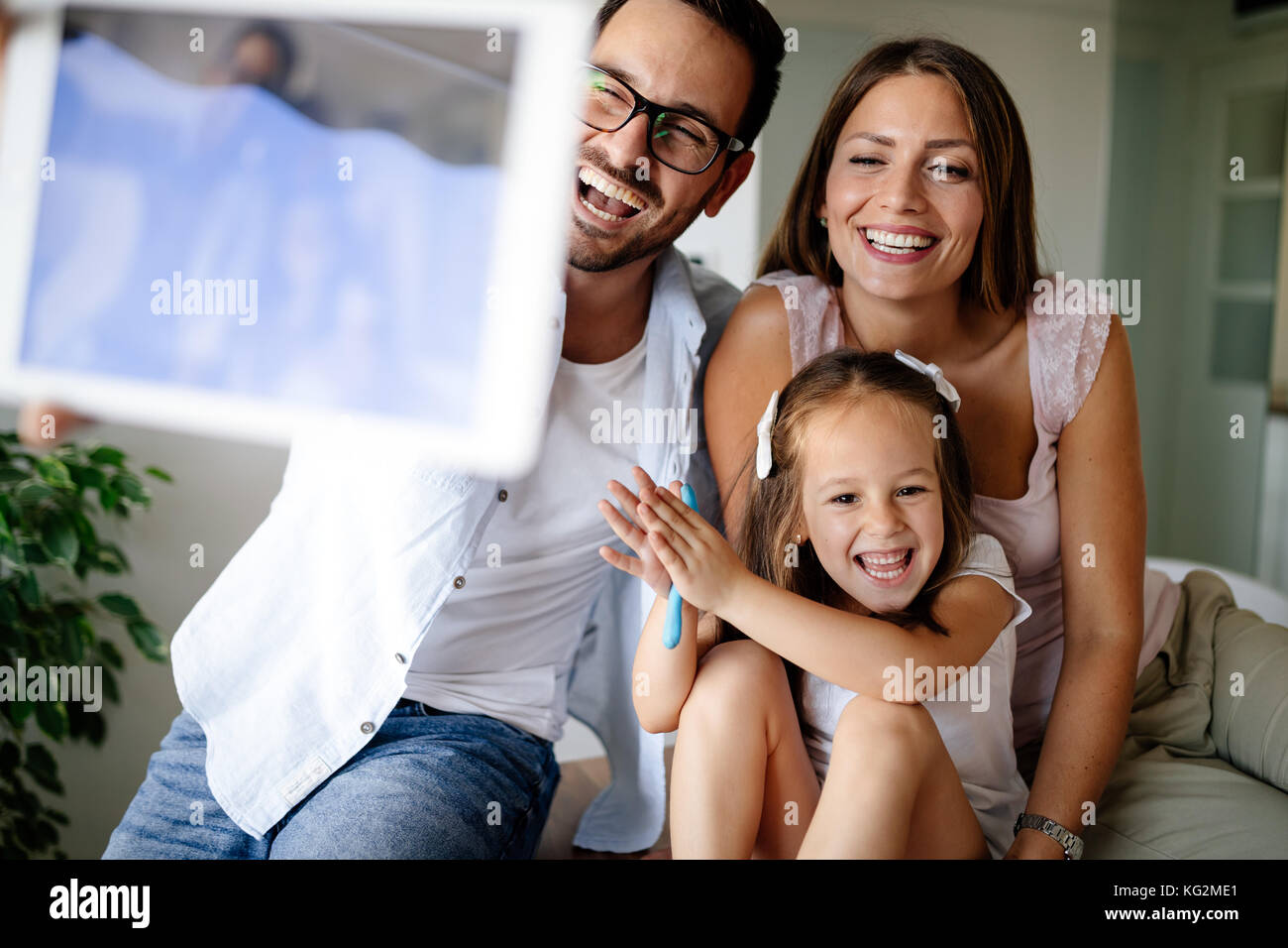 Happy family taking selfie in their house Stock Photo - Alamy